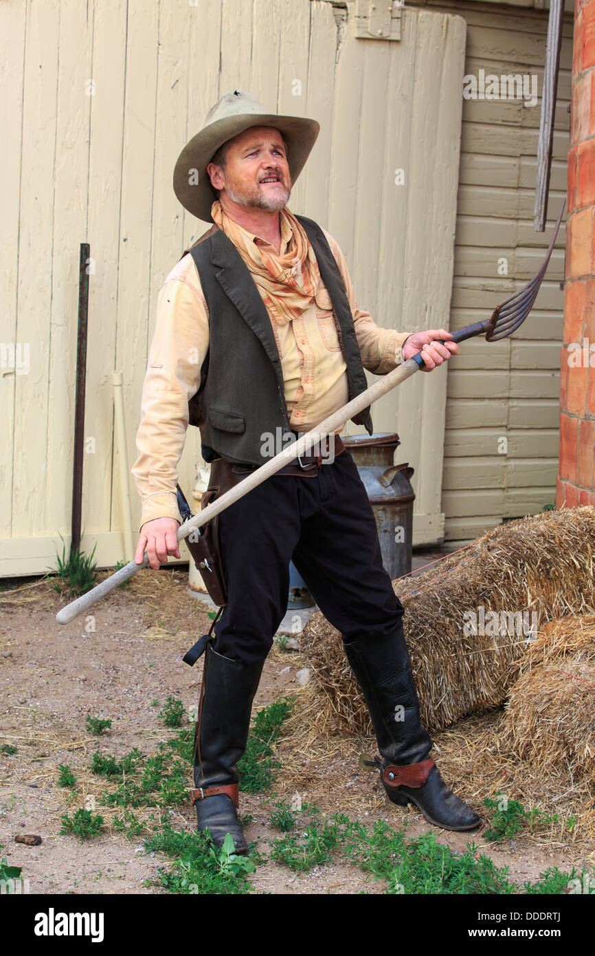 A rancher works on his chore of bailing hay at his barn Stock Photo - Alamy
