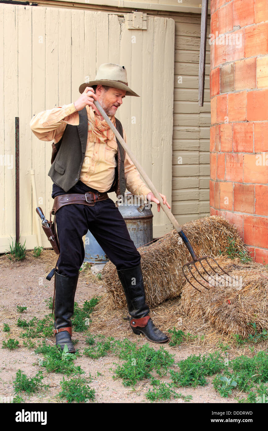 A rancher works on his chore of bailing hay at his barn Stock Photo - Alamy