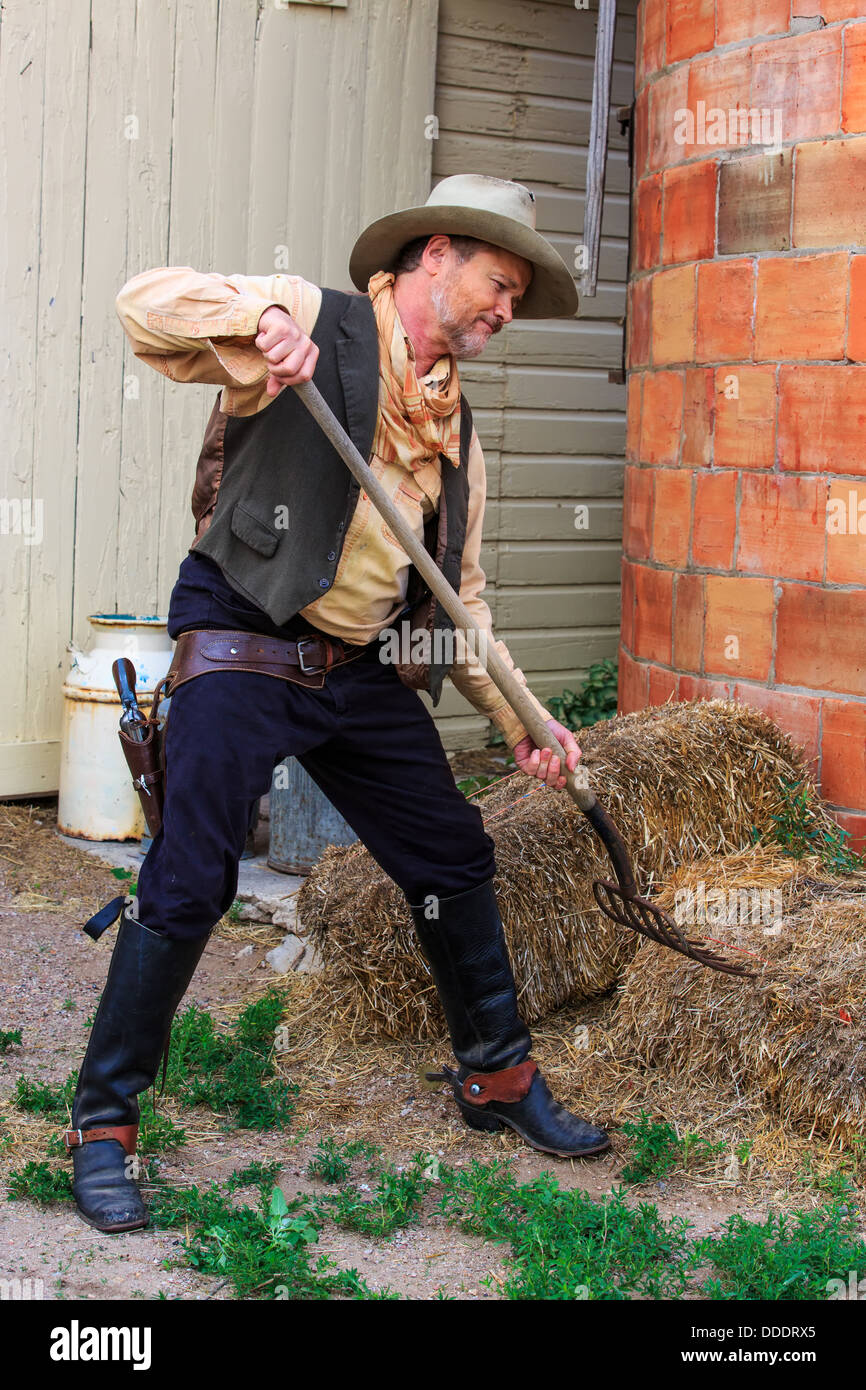 A rancher works on his chore of bailing hay at his barn Stock Photo - Alamy