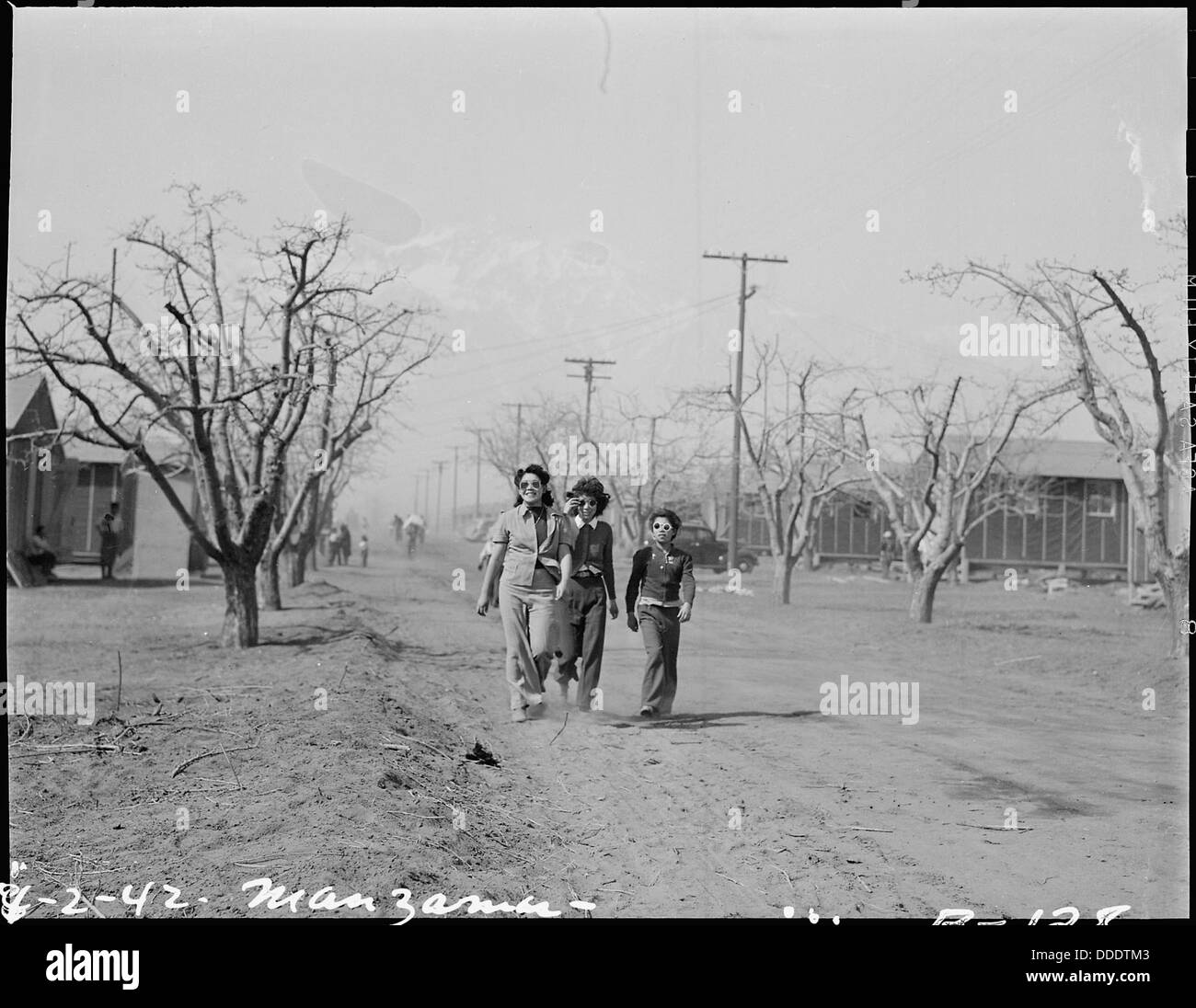 This photograph captures an afternoon stroll at the Manzanar Relocation ...