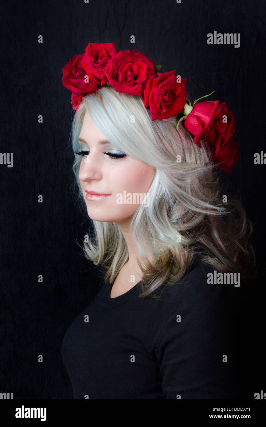 A beauty photograph of young woman/model adorned with red roses Stock ...
