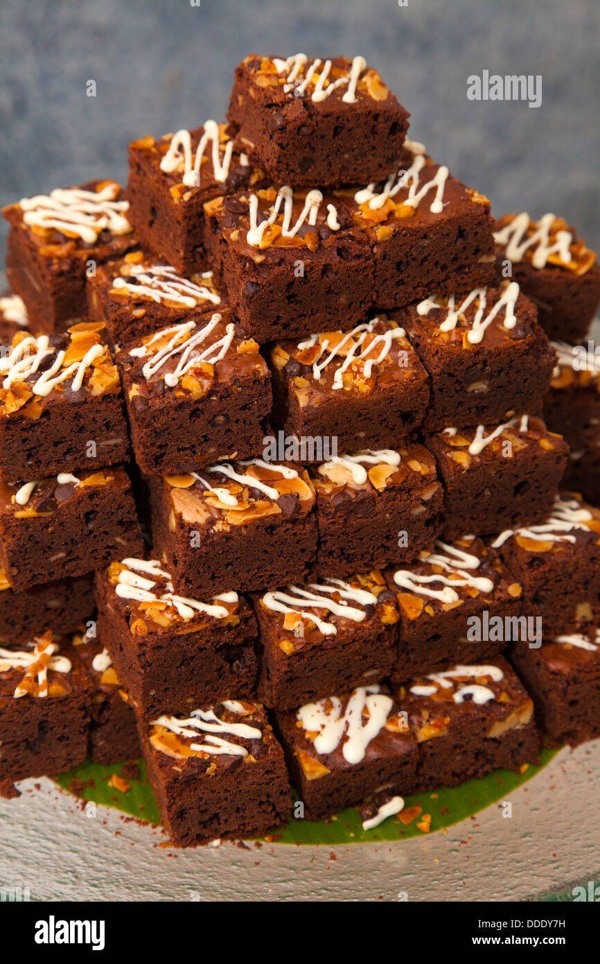 pile of square chocolate sweets served on glass plate on party table ...
