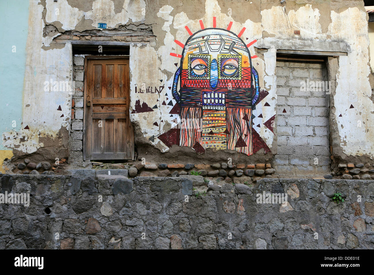 Street art graffiti of man wearing a colorful woolen balaclava mask, on ...
