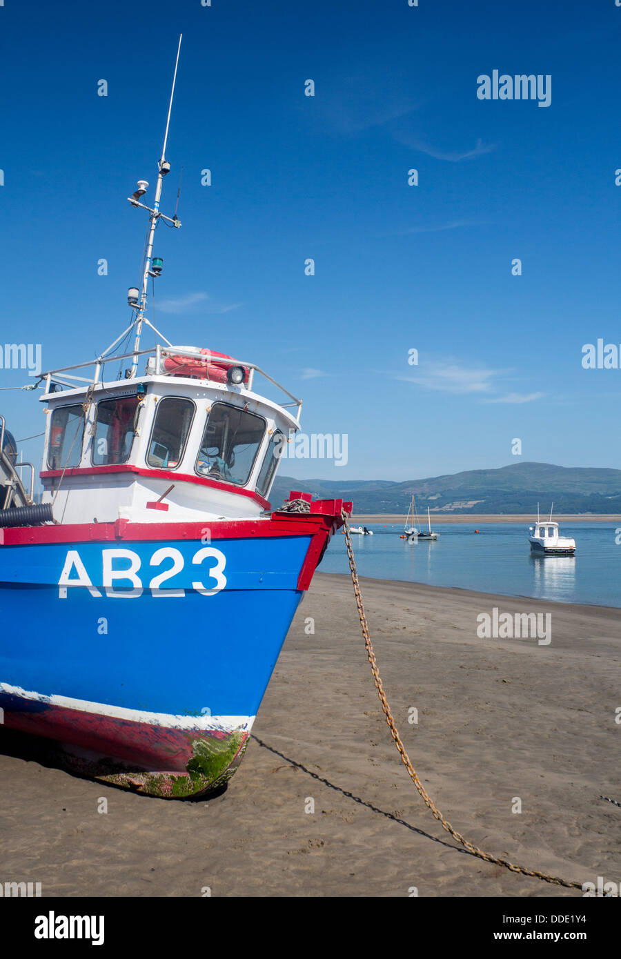 Fishing boat on beach at low tide in estuary Aberdovey Aberdyfi Gwynedd ...
