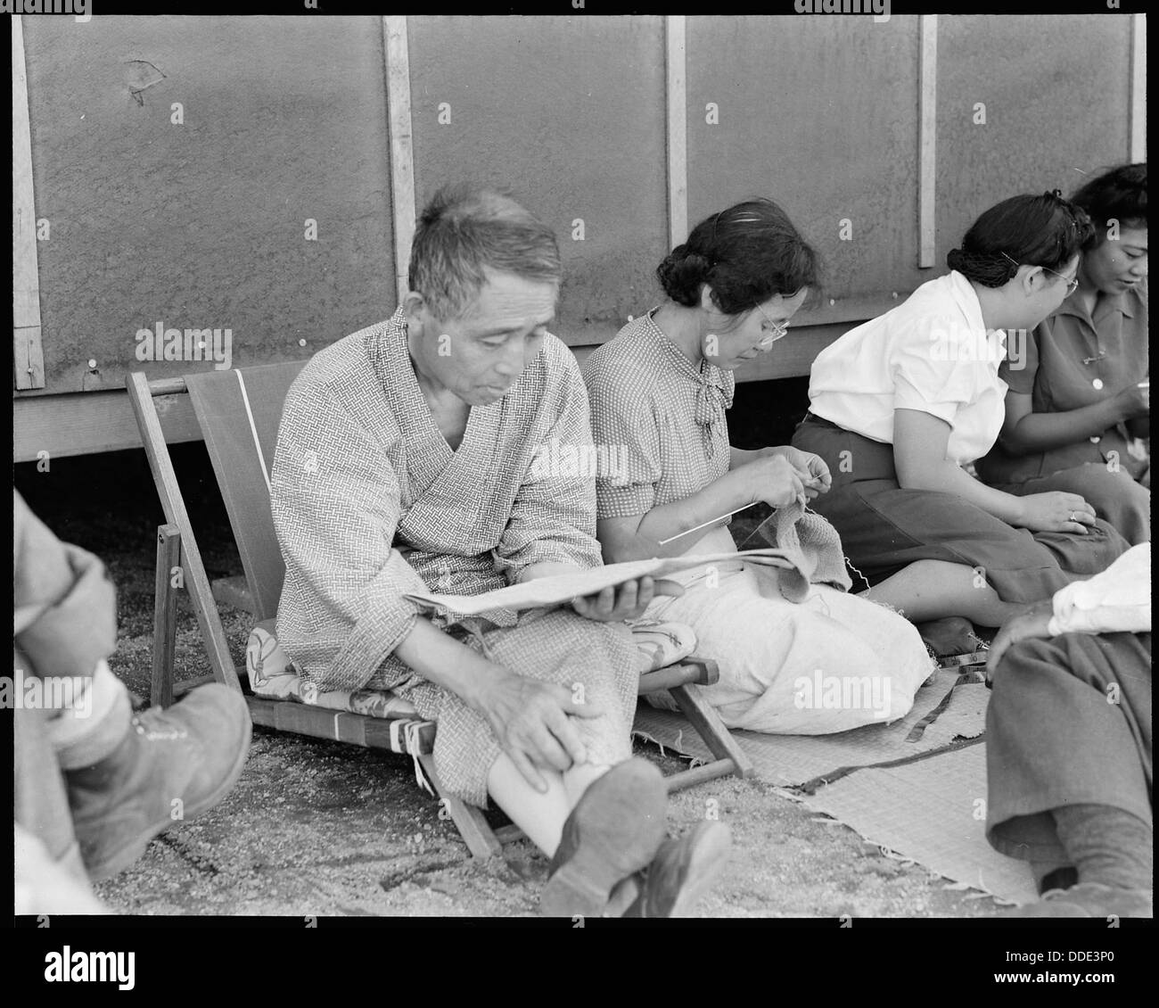 This photograph depicts evacuees of Japanese ancestry resting at the ...
