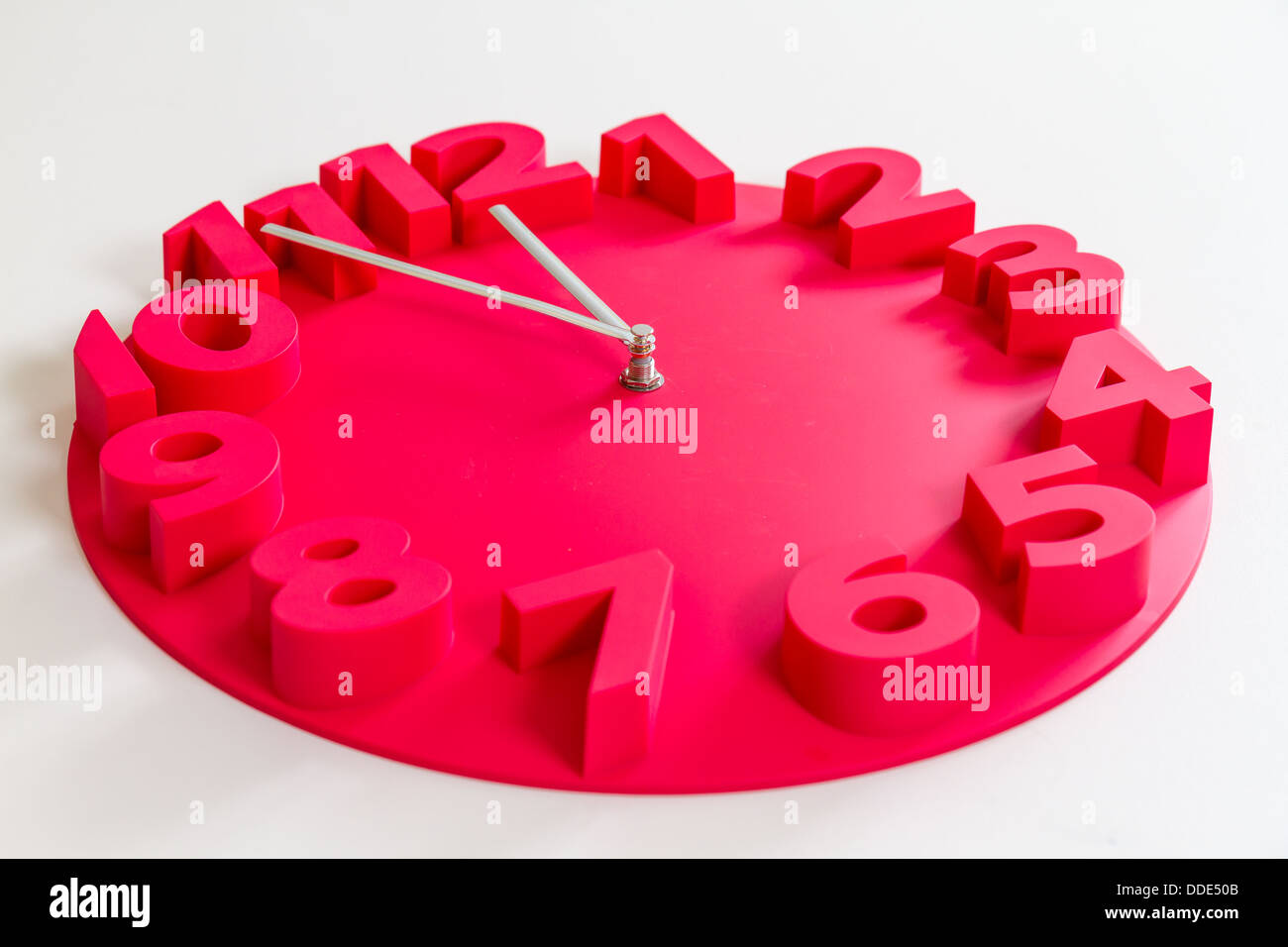 Red clock on isolated white showing five minutes to midnight Stock ...