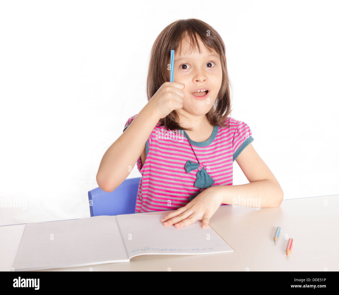 Child at desk with pencils and notebook Stock Photo - Alamy