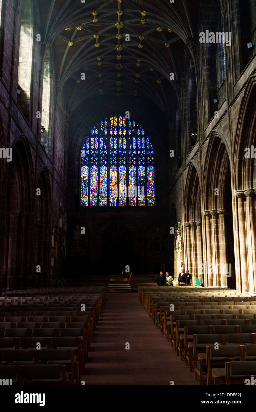 Sunlight on the pillars of the nave and the west window, stained glass ...