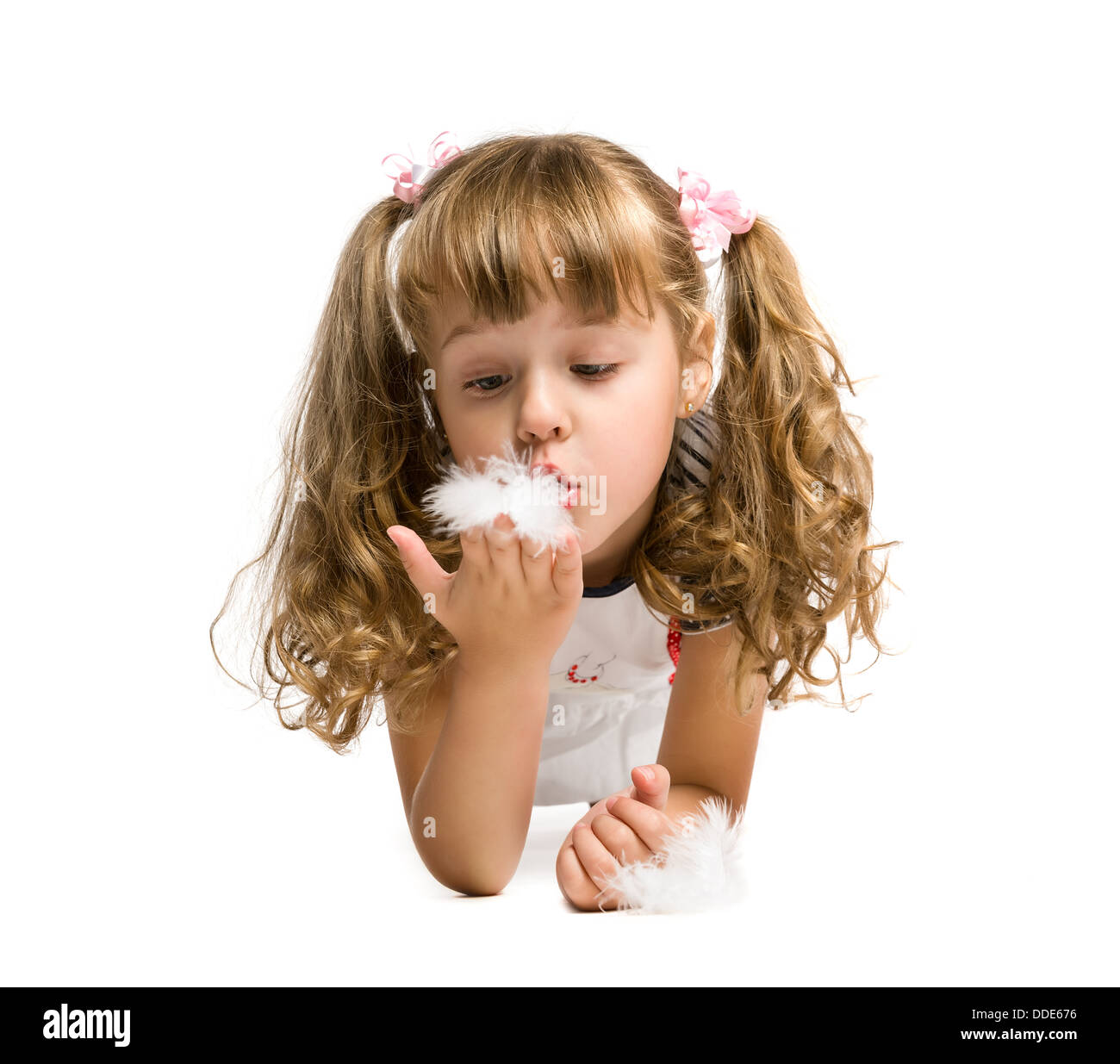 little girl blowing on a feather on a white background, isolated Stock ...