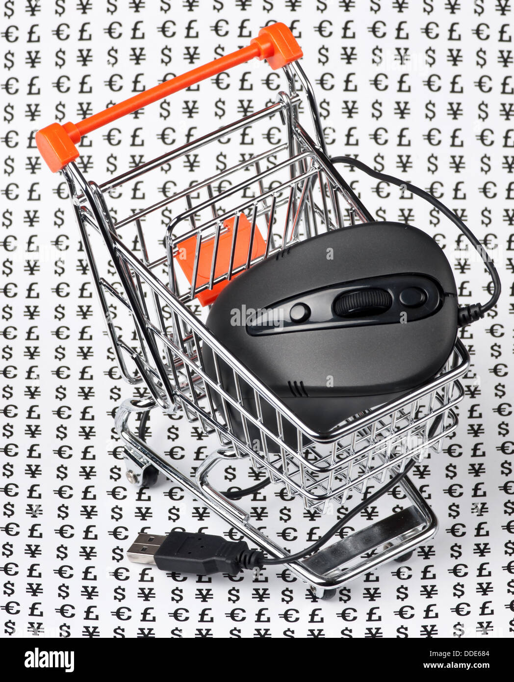 computer mouse in a shopping trolley on a background of signs of money ...