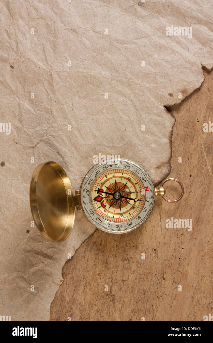 compass and a piece of old paper on a wooden board Stock Photo - Alamy