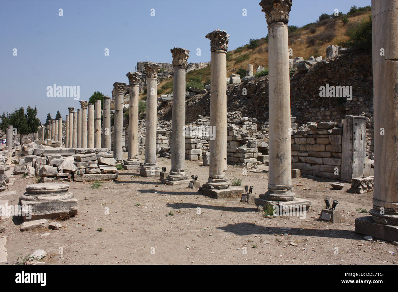 Street columns set between the ruins of the shops and the road in ...