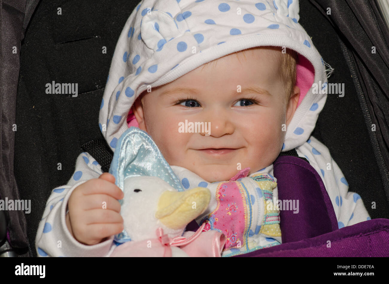 Smiling eight month old baby girl with Jemima Puddle Duck doll Stock ...