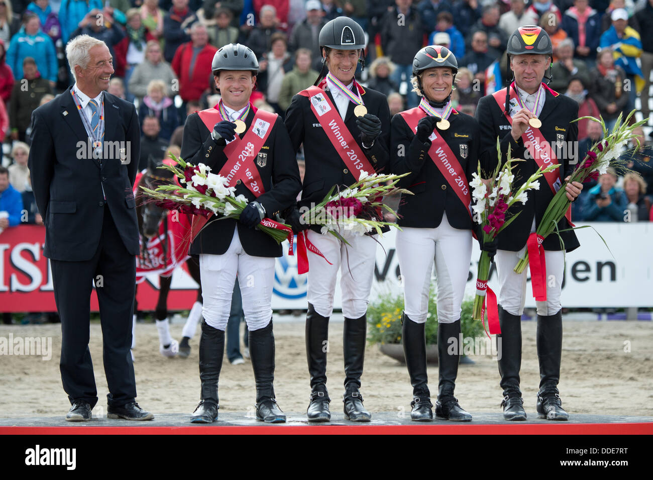 German coach Hans Melzer (L-R) stand next to the eventers Michael Jung ...
