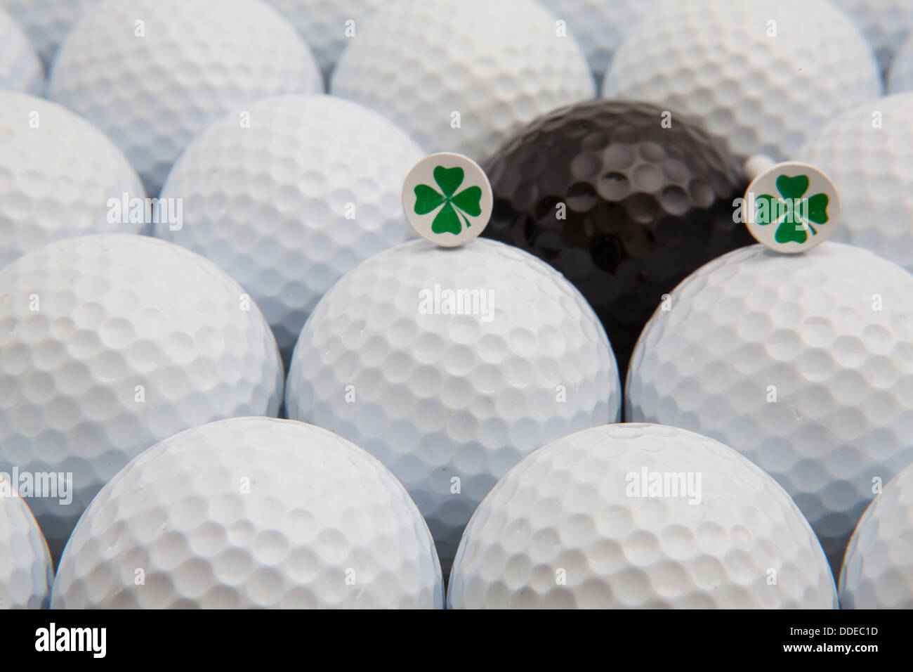 Different golf balls and wooden tees with four leaf clovers Stock Photo ...