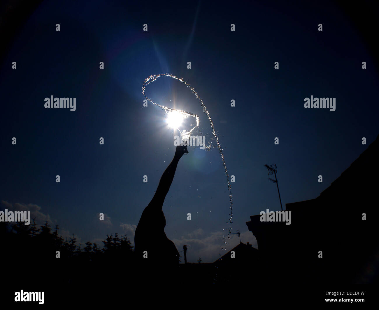 Man throwing water from a wine glass Stock Photo - Alamy