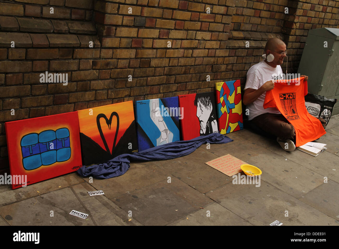 London, UK. 1 September 2013. A homeless street artist shows of his ...