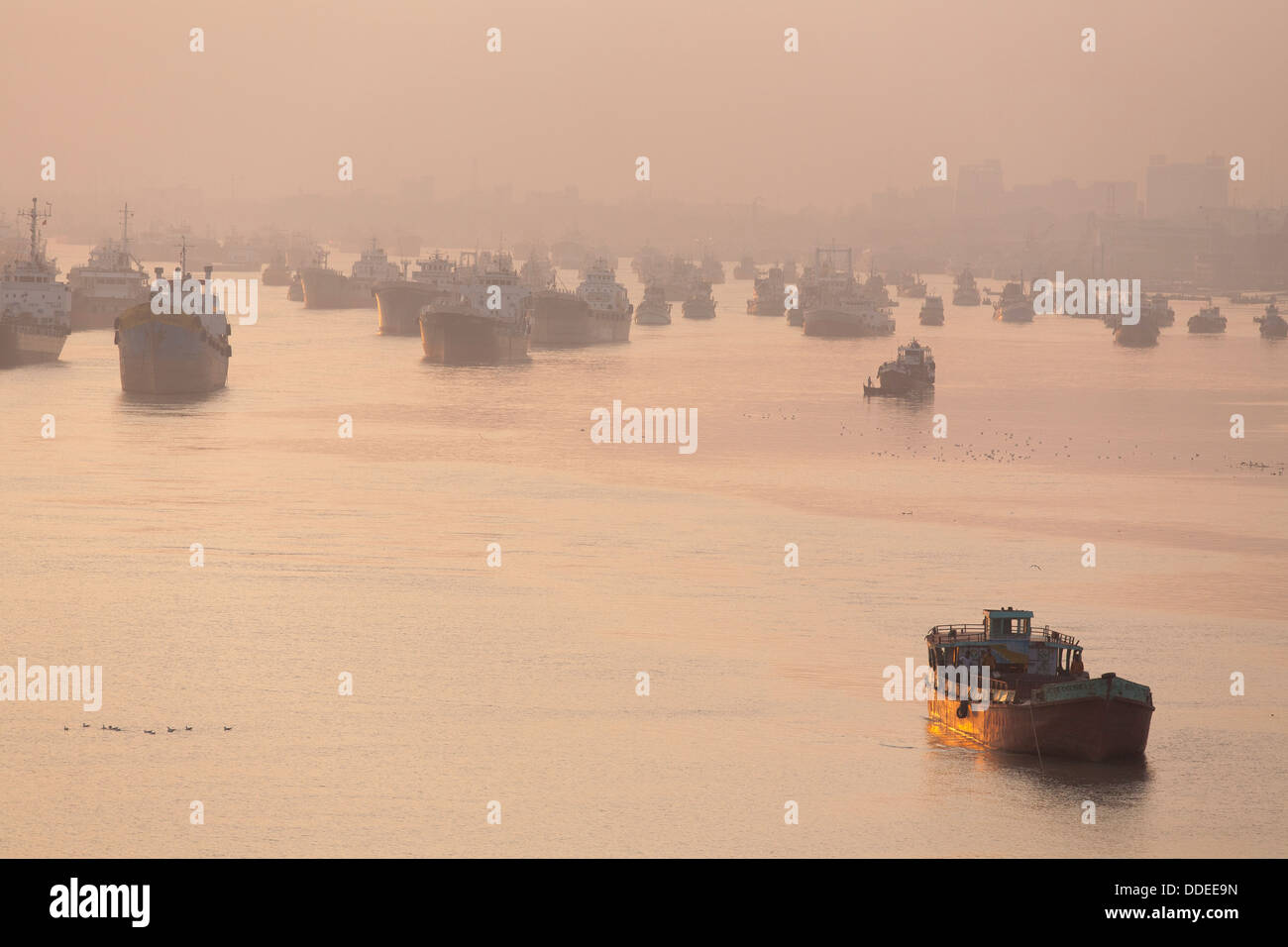 Cargo ships anchored at dusk in the Port of Chittagong on the ...
