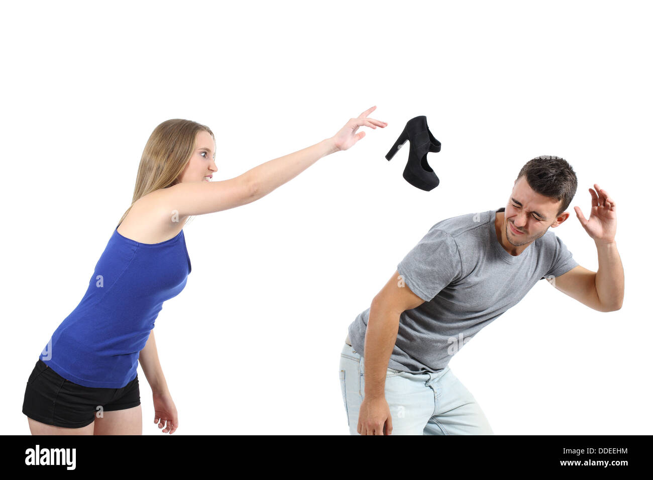 Woman throwing a heel shoe to a man isolated on a white background ...