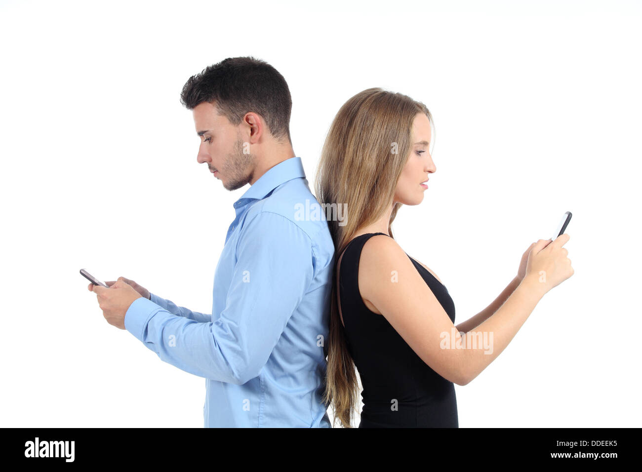 Attractive couple typing in their mobile phones isolated on a white ...