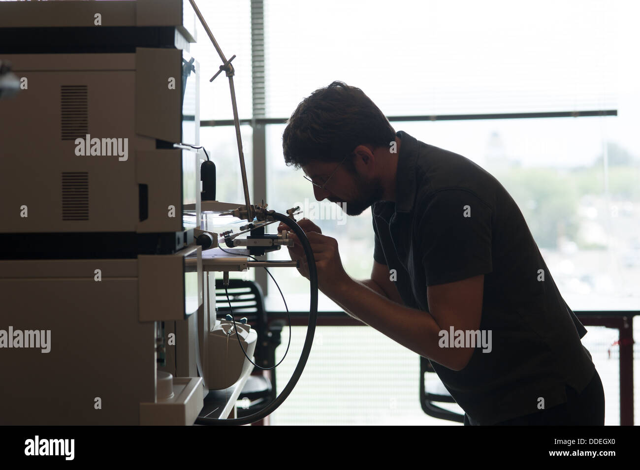 Researcher checking lab equipment Stock Photo - Alamy