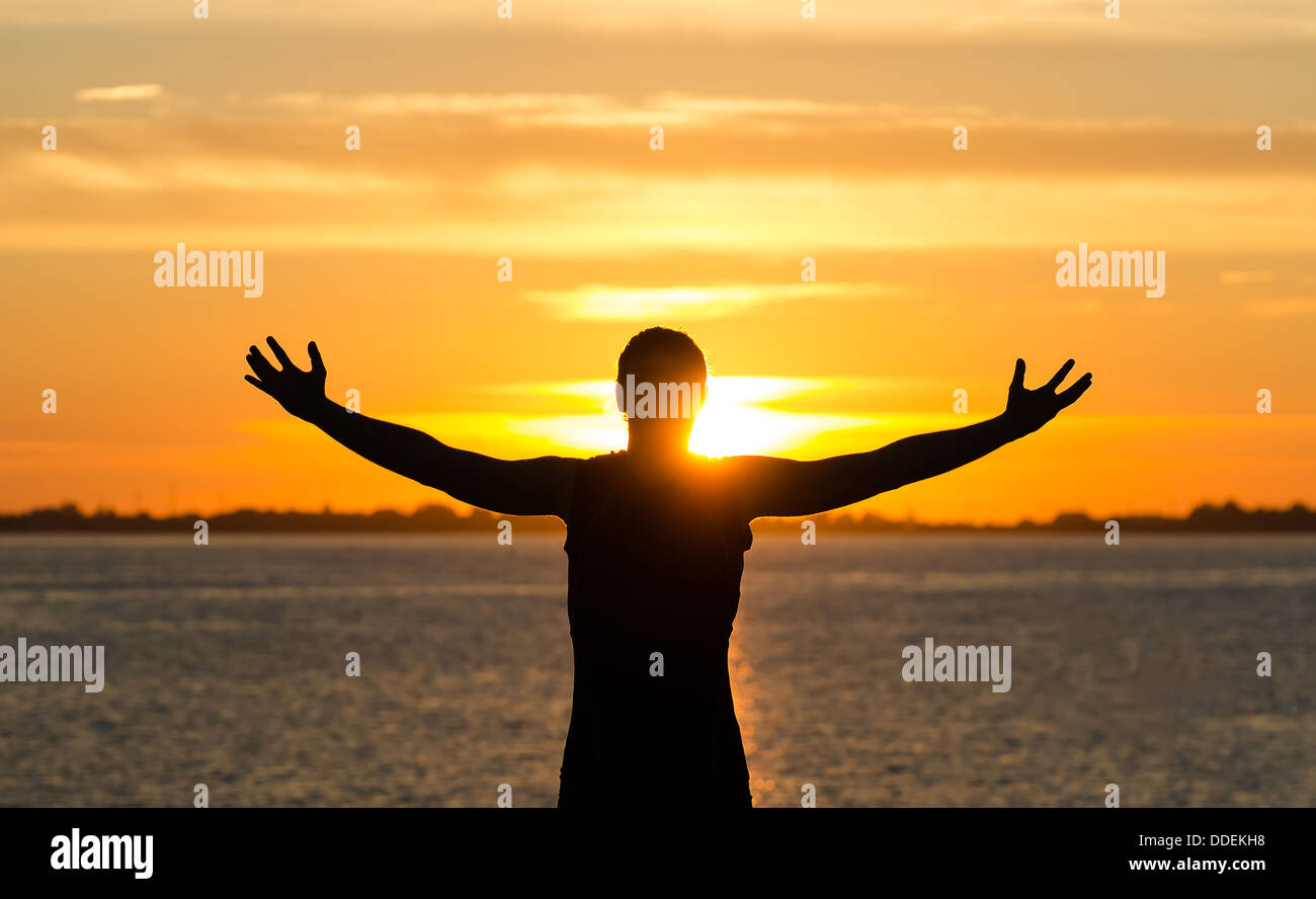 Man on the beach at sunrise Stock Photo - Alamy