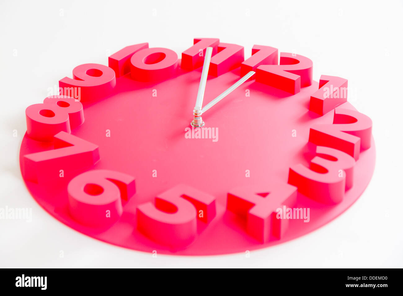 Red clock on isolated white showing five minutes to midnight Stock ...