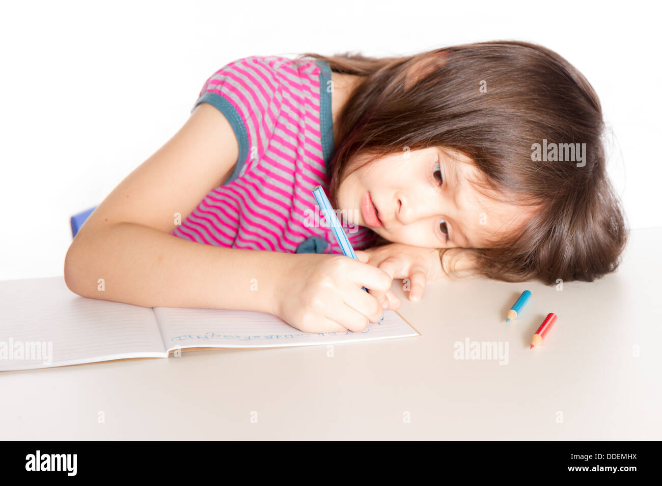 Child at desk with pencils and notebook Stock Photo - Alamy