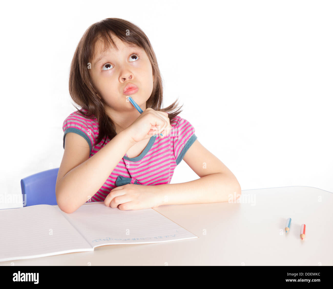 Child at desk with pencils and notebook Stock Photo - Alamy