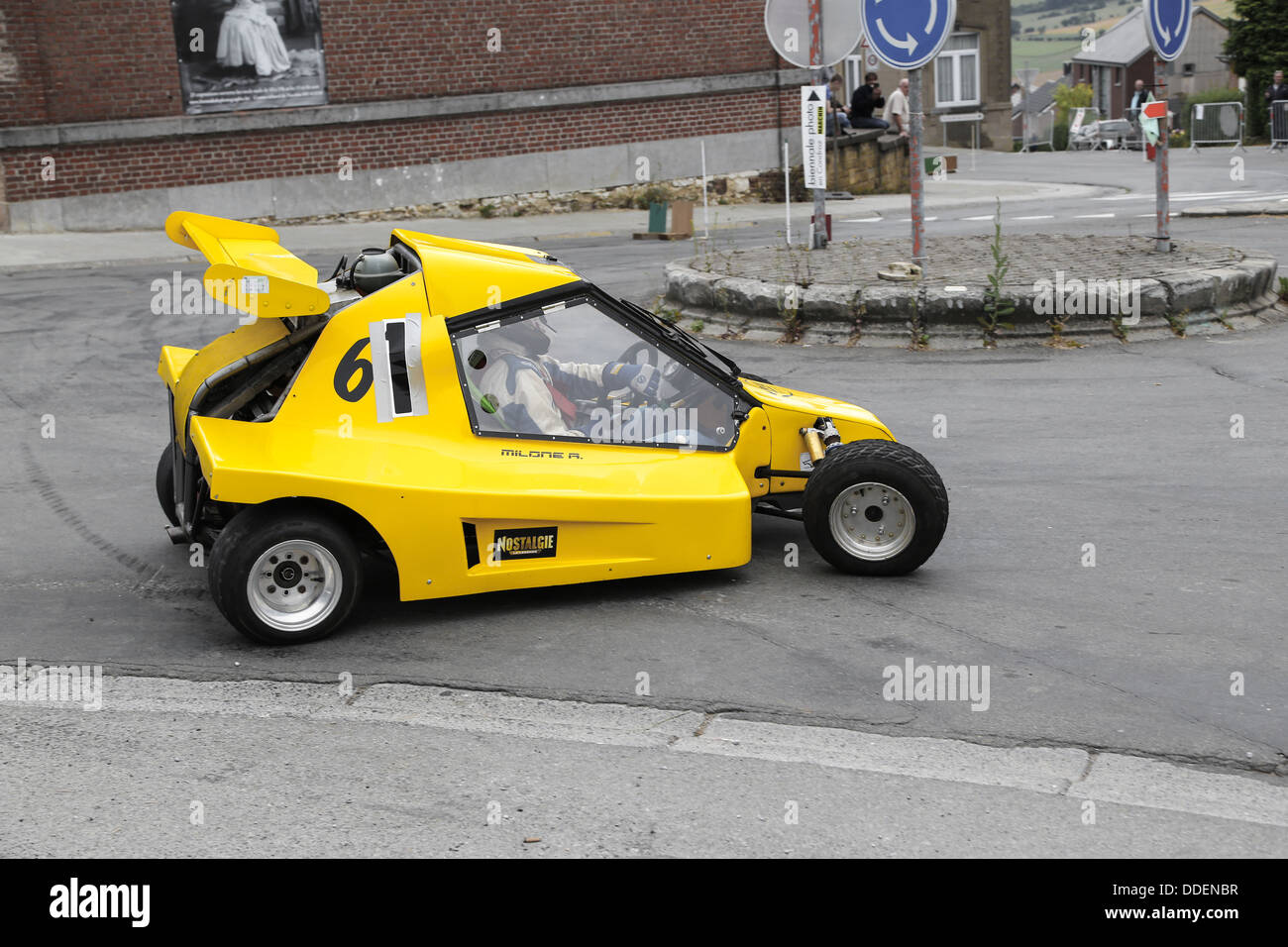 Yellow racing buggy drifting in a curve on an asphalt track. Slalom ...