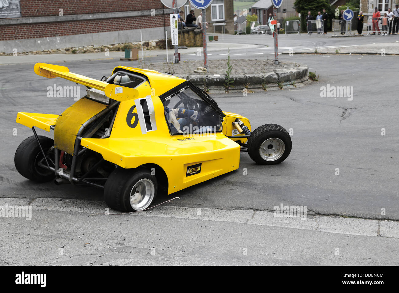 Yellow racing buggy drifting in a curve on an asphalt track. Slalom ...