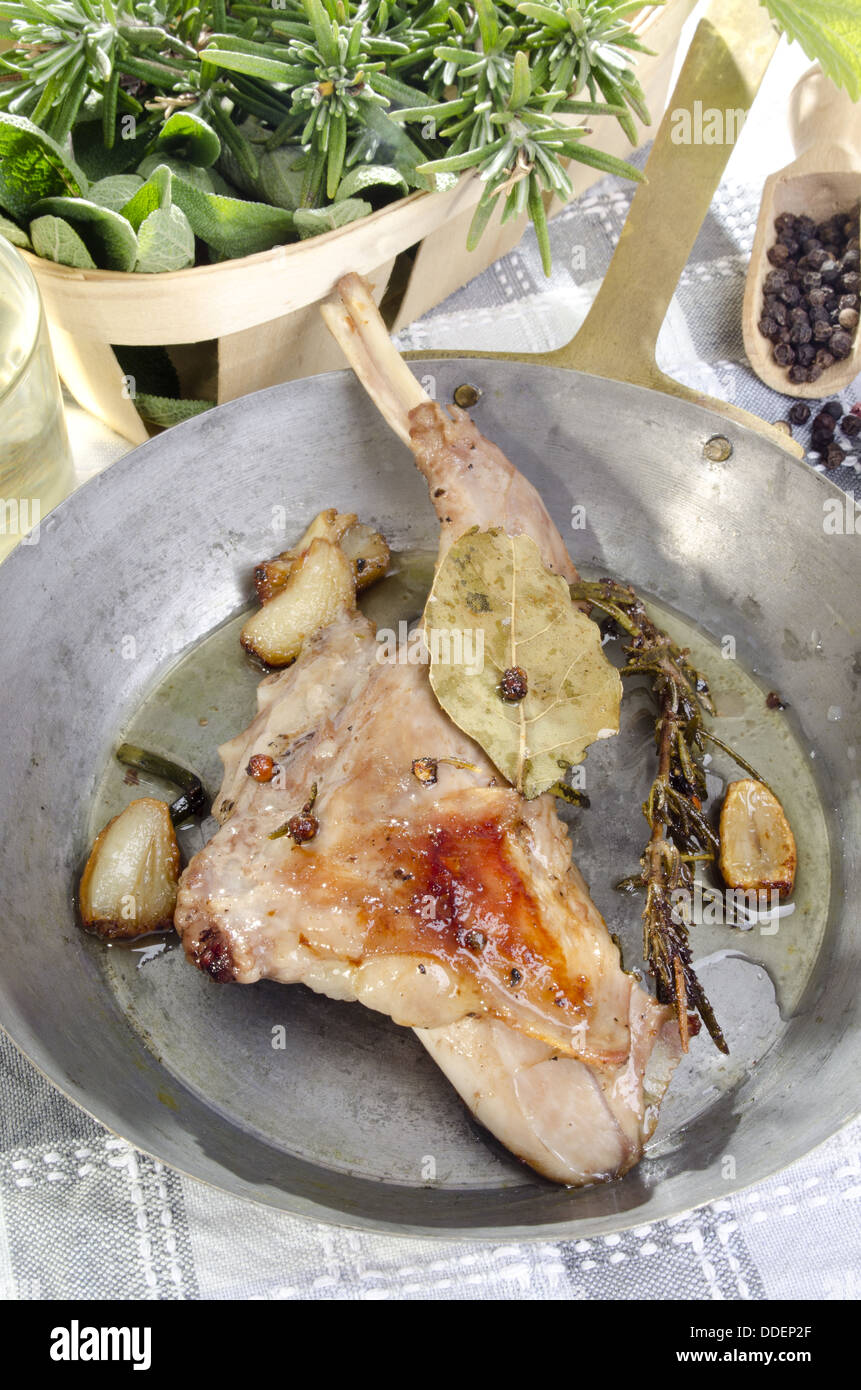 rabbit leg with herbs in a brassr pan Stock Photo - Alamy