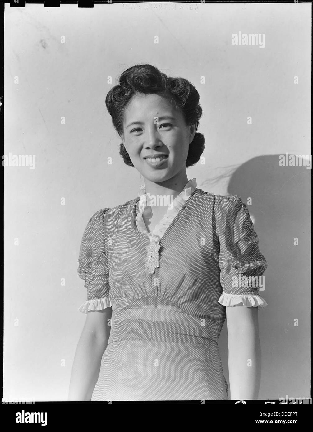 This image shows Mrs. Togo Tanaka, a young American-born mother, at the ...