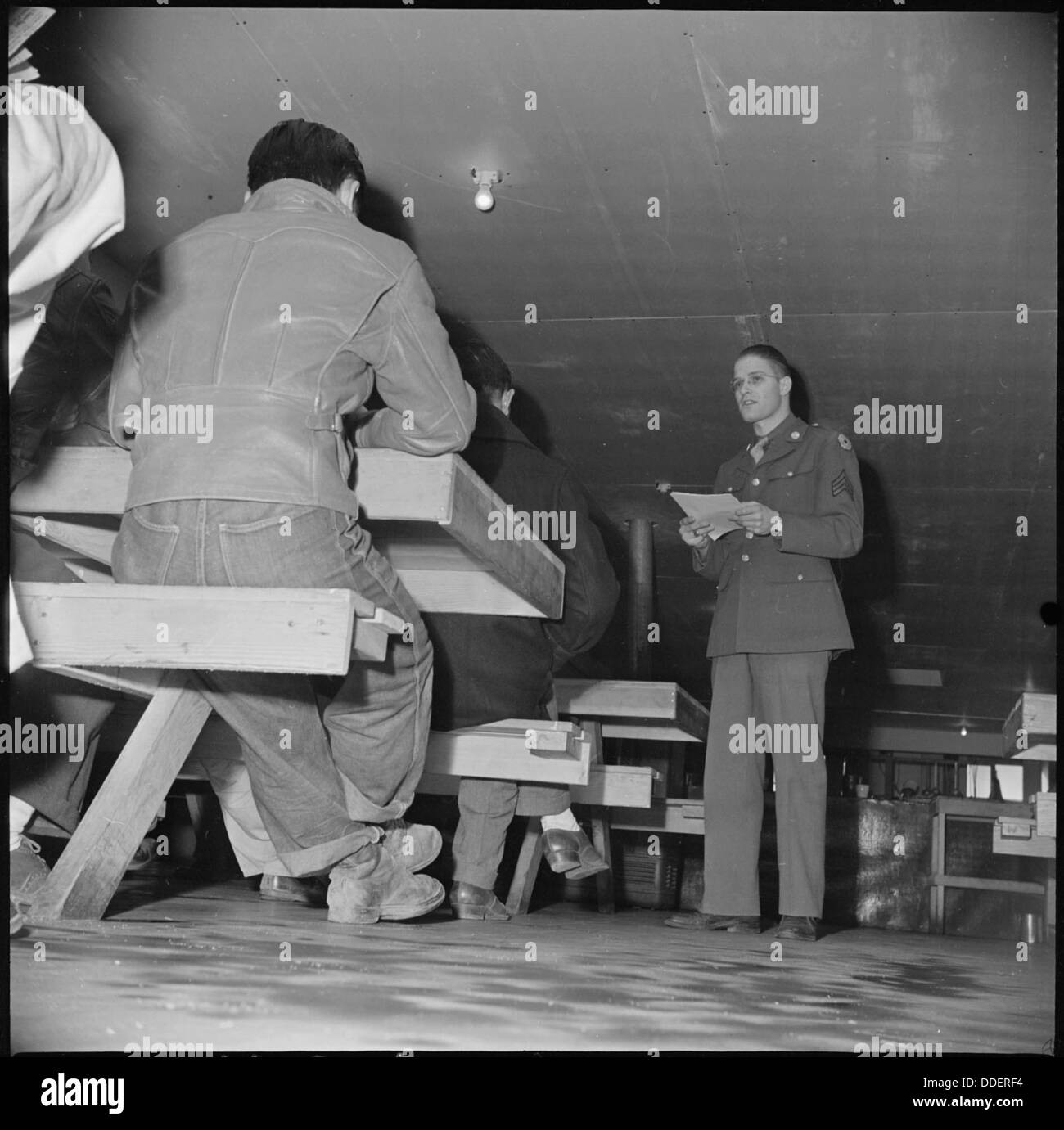 A historical image of Sergeant Victor Tierman explaining the purpose of ...