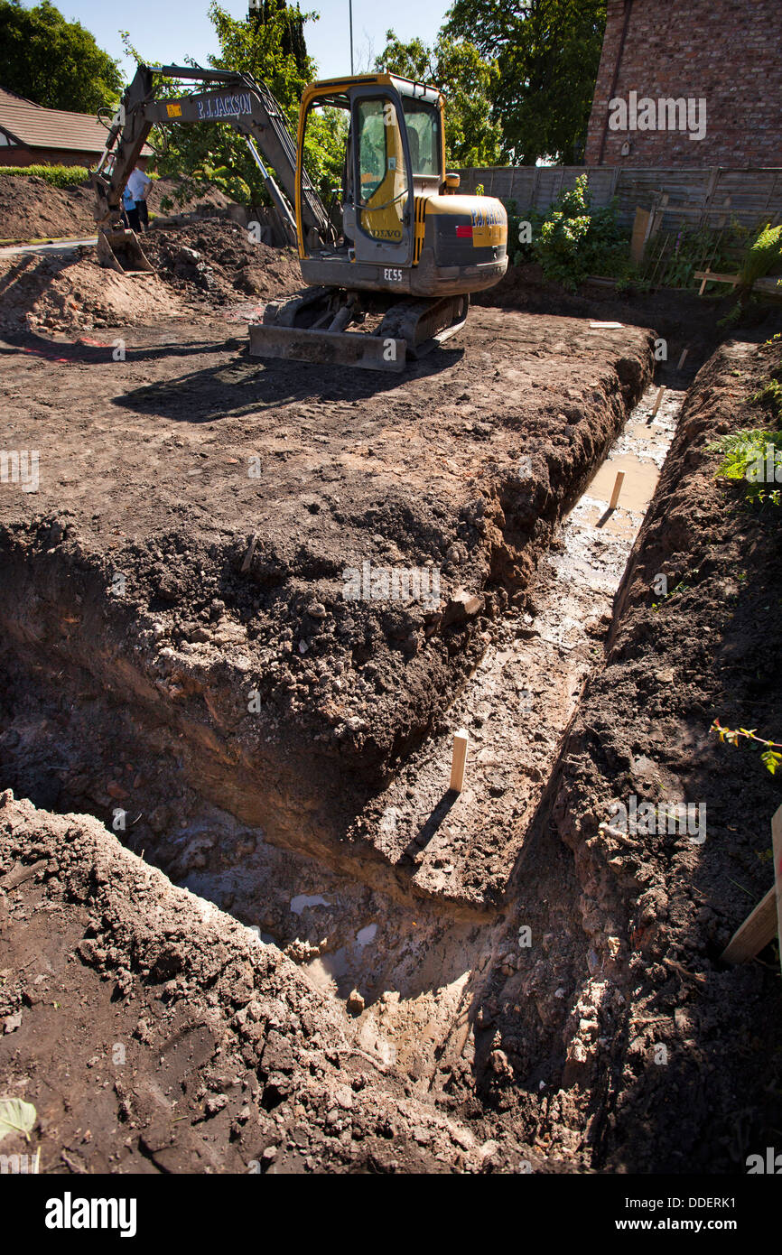 self building house, volvo digger preparing site after concrete ...