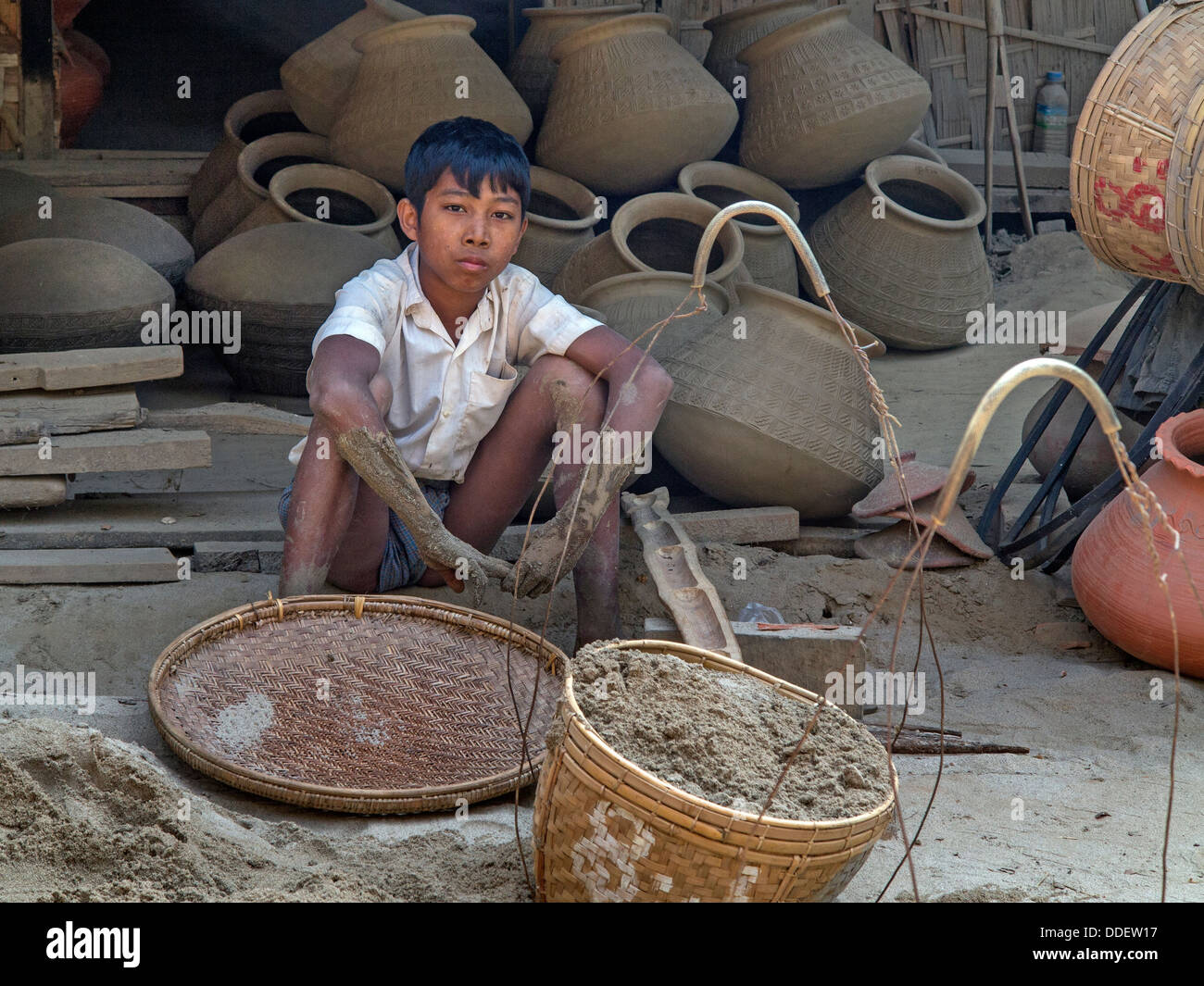 Boy carrying clay in traditional pottery Mandalay Myanmar Stock Photo ...