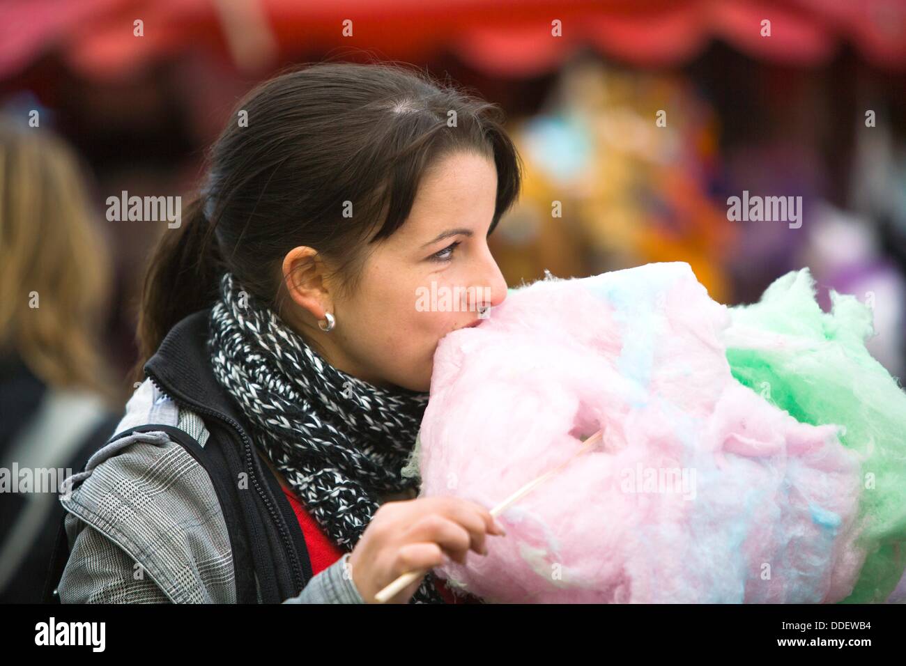 Woman eating pink candy floss hi-res stock photography and images - Alamy