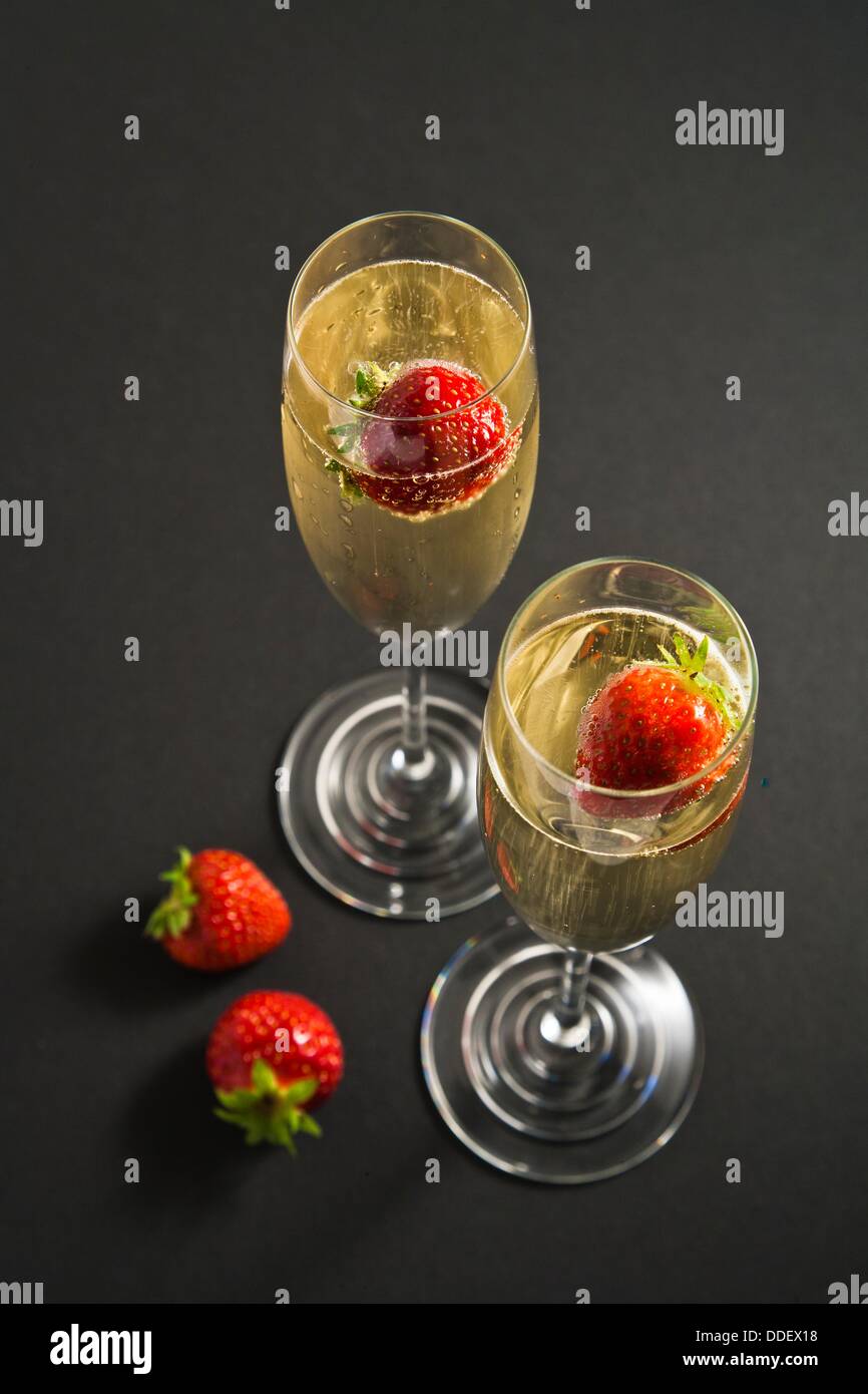 Strawberries and champagne in champagne flutes Stock Photo - Alamy