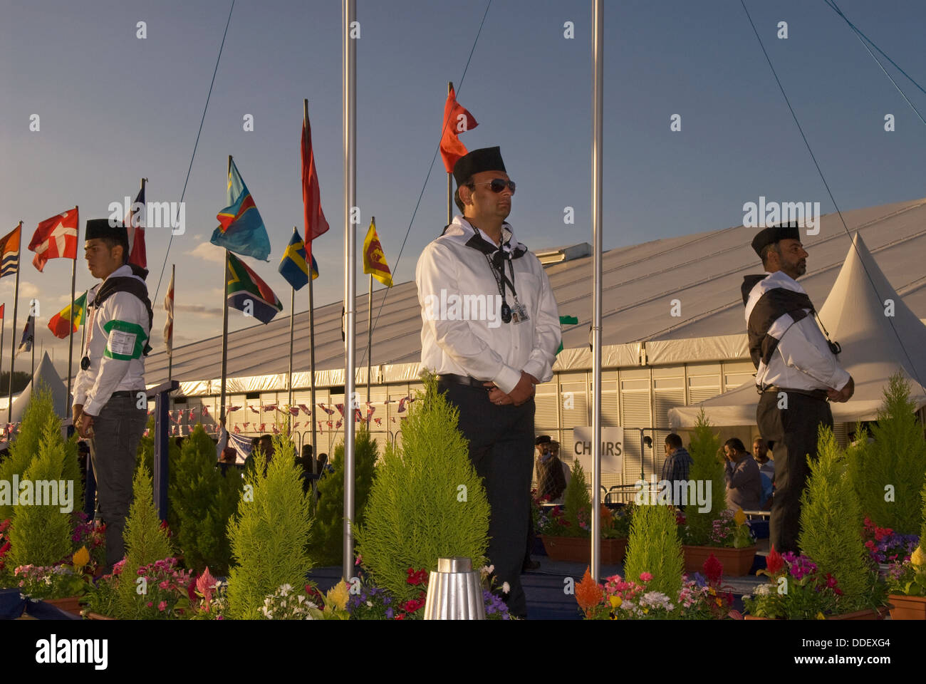 Muslims standing amidst national flags as a mark of respect to host ...