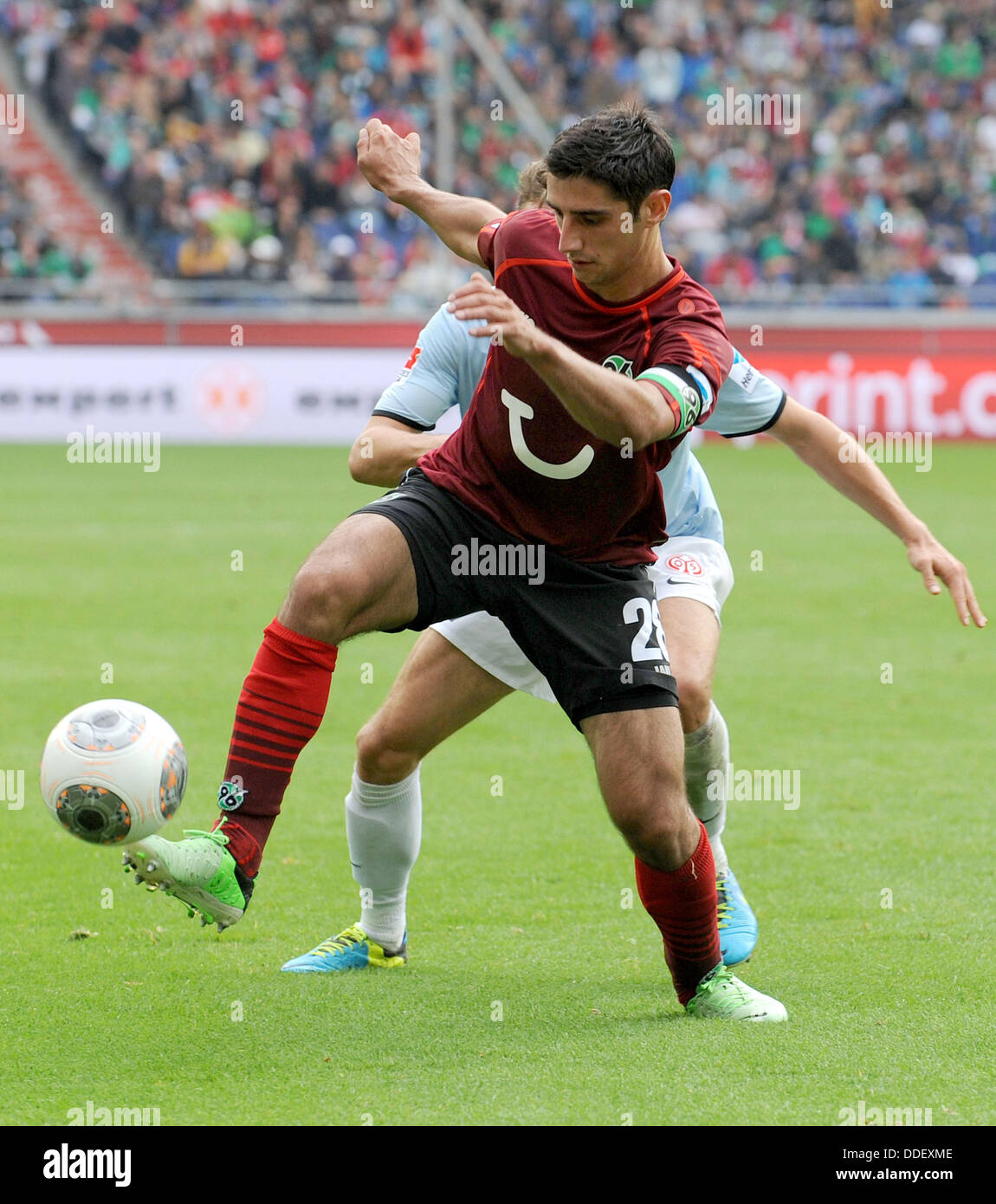 Hanover, Germany. 31st Aug, 2013. Hanover's Lars Stindl (L) shields the ...