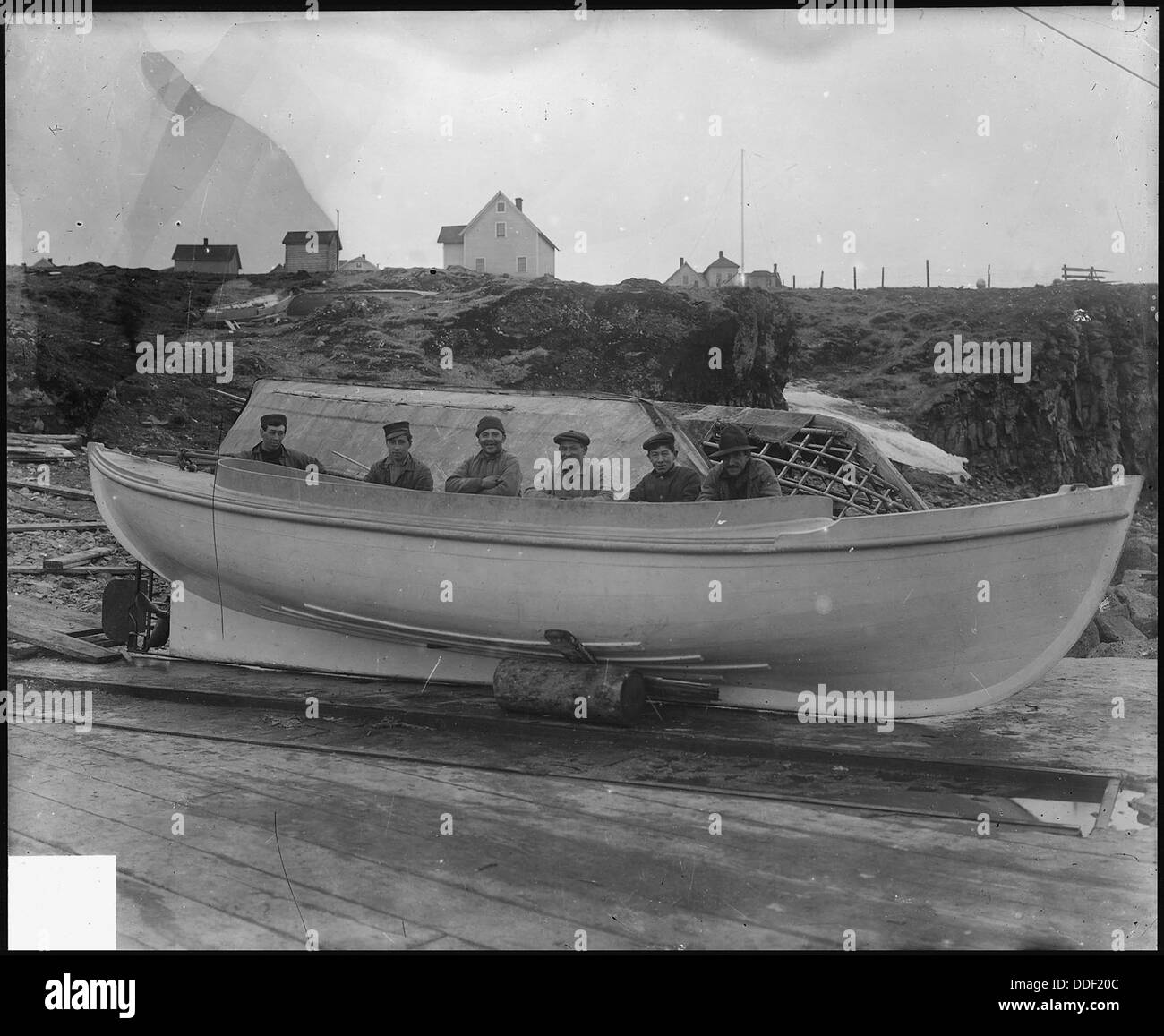 The image depicts boat builders working on wooden boats, possibly along ...