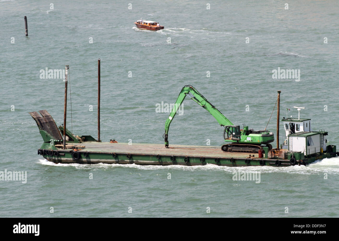 transport boat with a heavy bulldozer over heads to the shipyard in ...