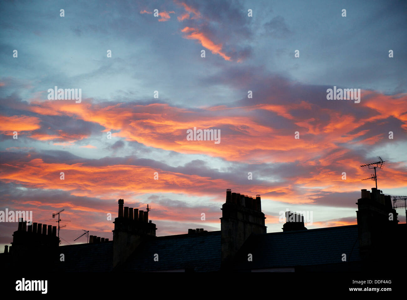 Sunset above roof tops Stock Photo - Alamy