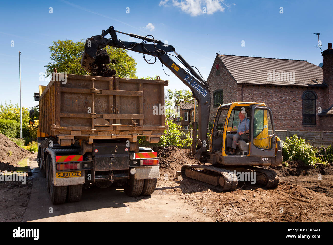 self building house, volvo digger preparing garden, loading spoil onto ...