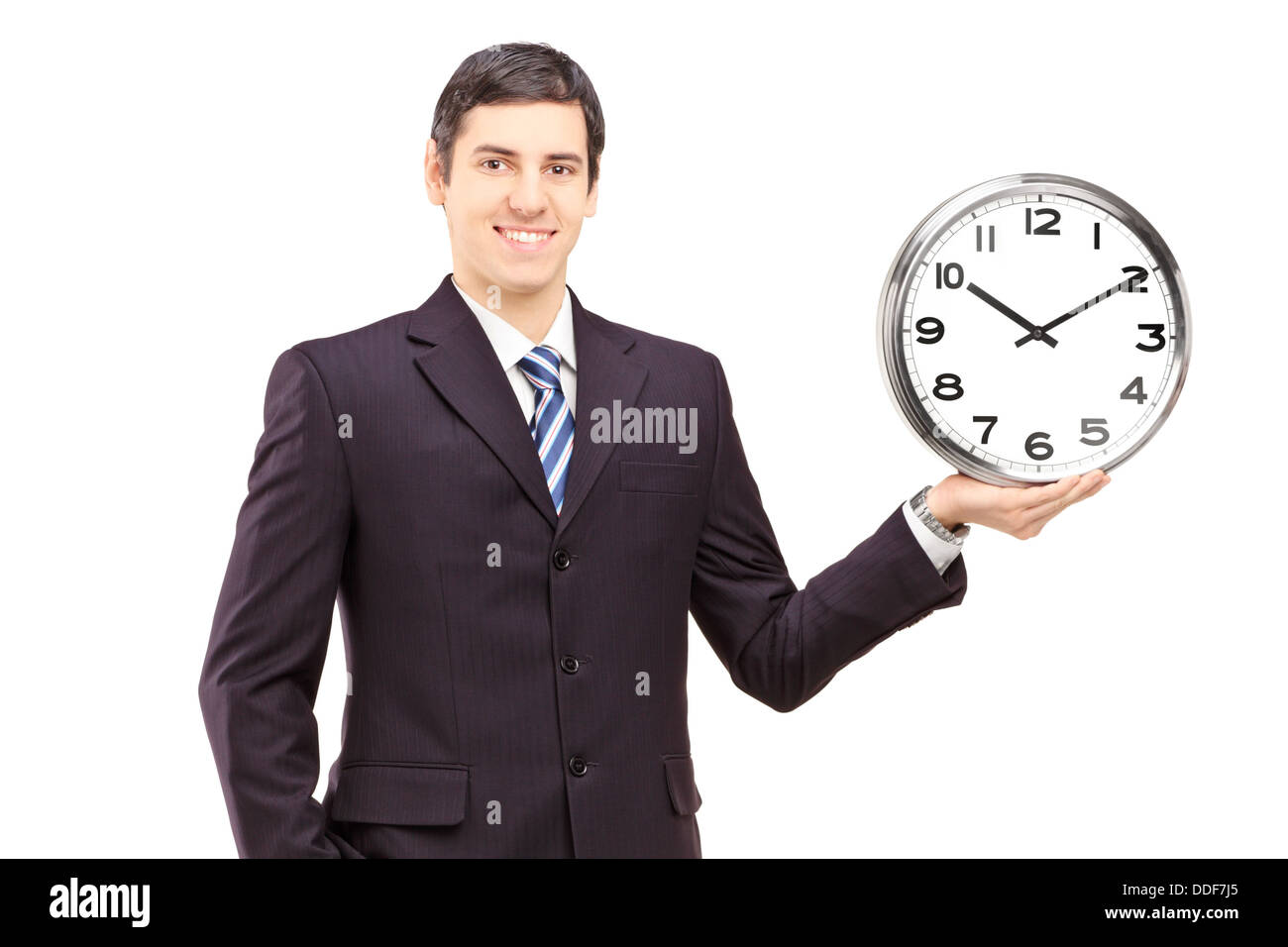 Young man in suit holding a clock Stock Photo - Alamy