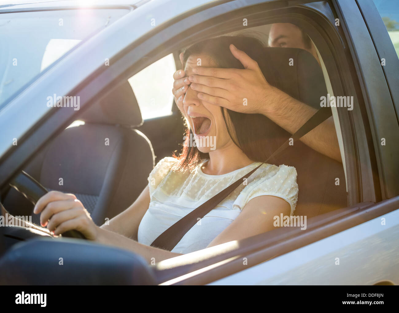 Young couple in car - man covering eyes of his girlfriend Stock Photo ...