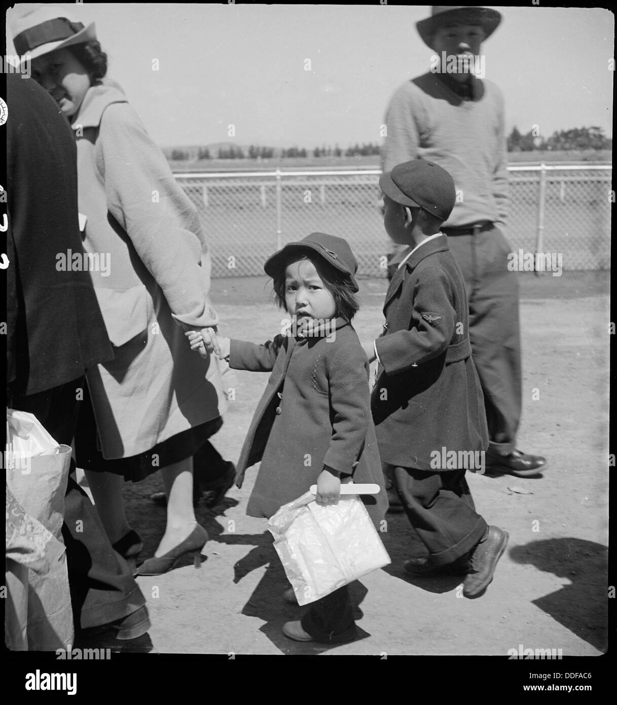 A Japanese American family arrives at the Tanforan Race Track assembly ...