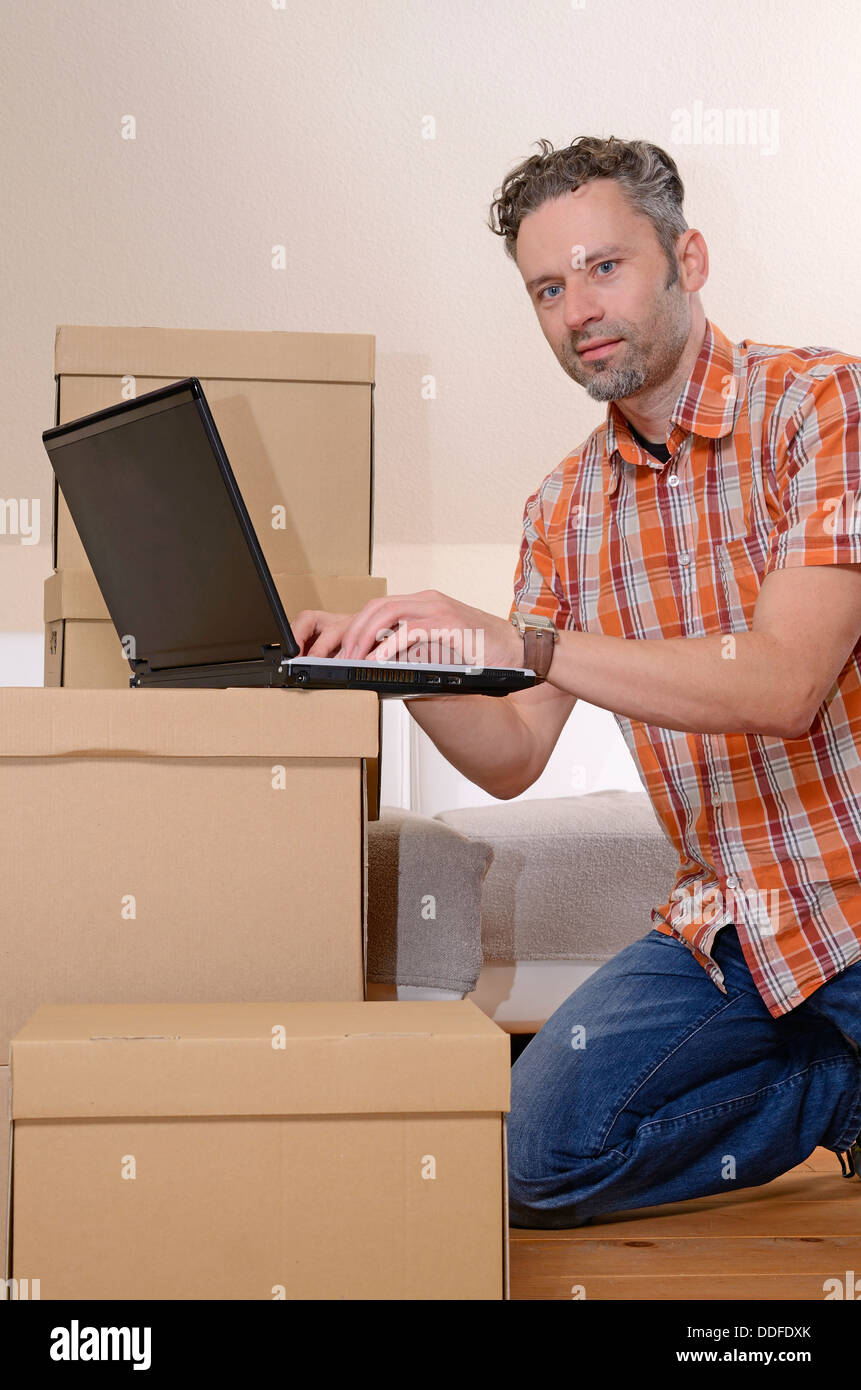 Happy man moving in new home Stock Photo - Alamy