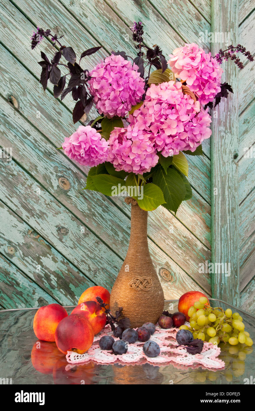 pink hydrangea and violet basil bouquet in a vintage vase still life ...