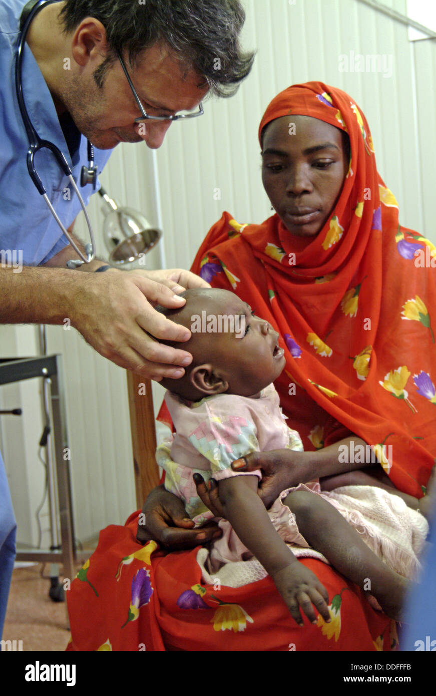 Male african doctor examining baby hi-res stock photography and images ...